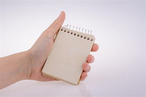 Premium Photo Hand Holding A Notebook
