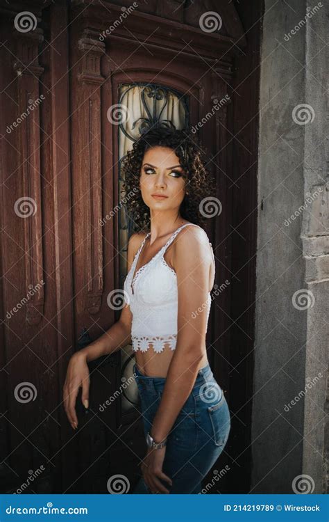 Vertical Shot Of A Young Bosnian Girl Posing In Front Of A Wooden Door Stock Image Image Of