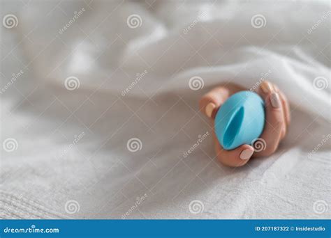 A Faceless Woman Lies In Bed Under A Blanket Holding A Clitoral Vibrator The Girl Masturbates