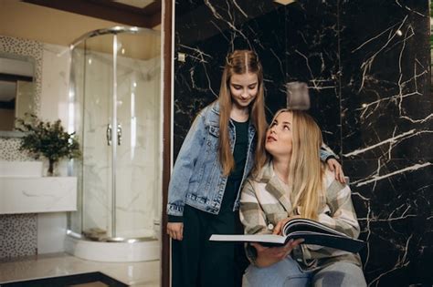 Premium Photo Mother And Daughter Choose Tiles For The Bathroom