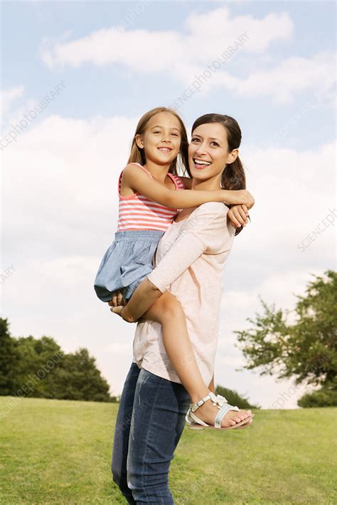 Mother Carrying Daughter Stock Image F Science Photo Library