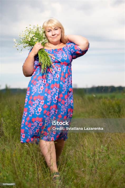 Beautiful Plus Size Woman With White Hair In A Summer Dress Posing Outdoors With Daisies Chubby