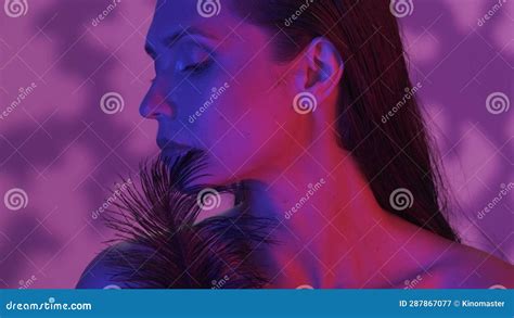 Close Up Side Profile Video Of A Young Woman Calmly Looking Away Feather Falling Down The Face
