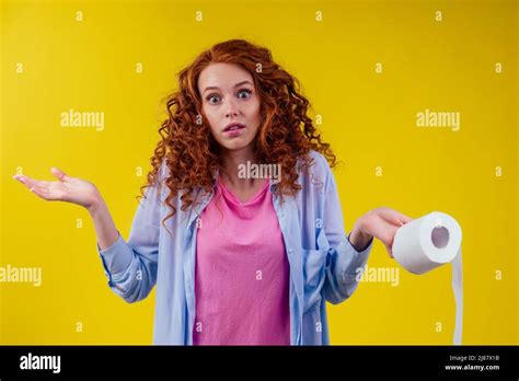 Beautiful Curly Redhead Ginger Woman Holding Eco Toilet Paper Roll On Yellow Color Background