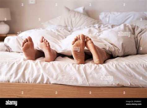 Stay In Bed All Day Challenge Accepted A Couples Feet Poking Out From Under The Bed Sheets