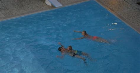 Mom Dad And Son Bathing In The Pool Father Swimming On The Back And