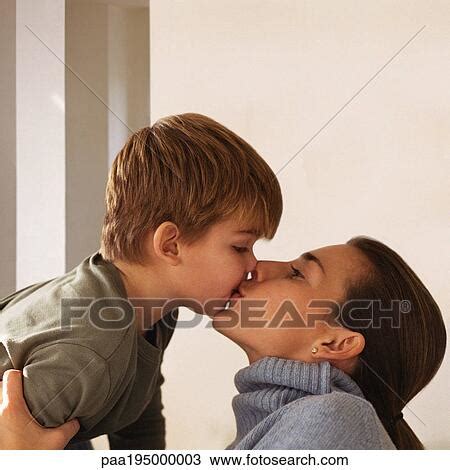 Stock Photo Of Mother Kissing Son Head And Shoulders Side View