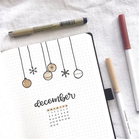 An Open Notebook With The Word December Written On It Next To Some