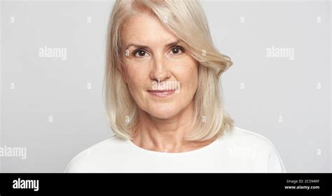 Beautiful Old Woman Is Smiling Isolated On Grey Stock Photo Alamy